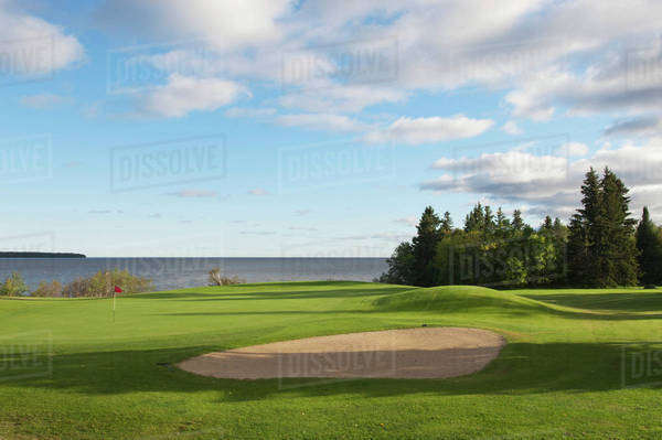Golf course putting green and pin on lake; hecla island manitoba canada ...