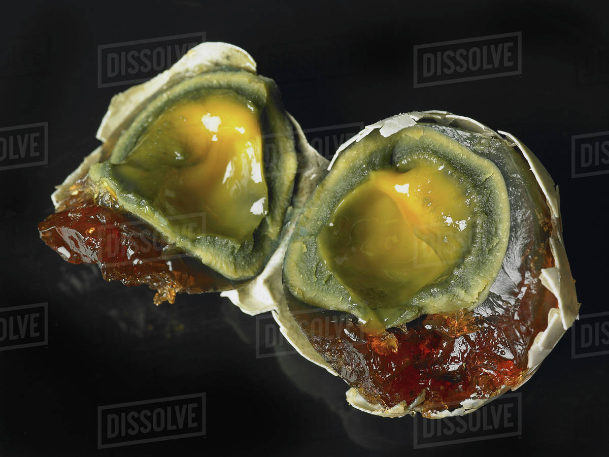 Open eggs on a black background - Stock Photo - Dissolve