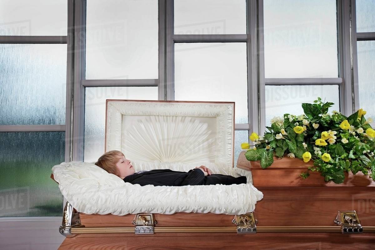A Boy's Body Laying In A Coffin - Royalty-free Stock Photo | Dissolve