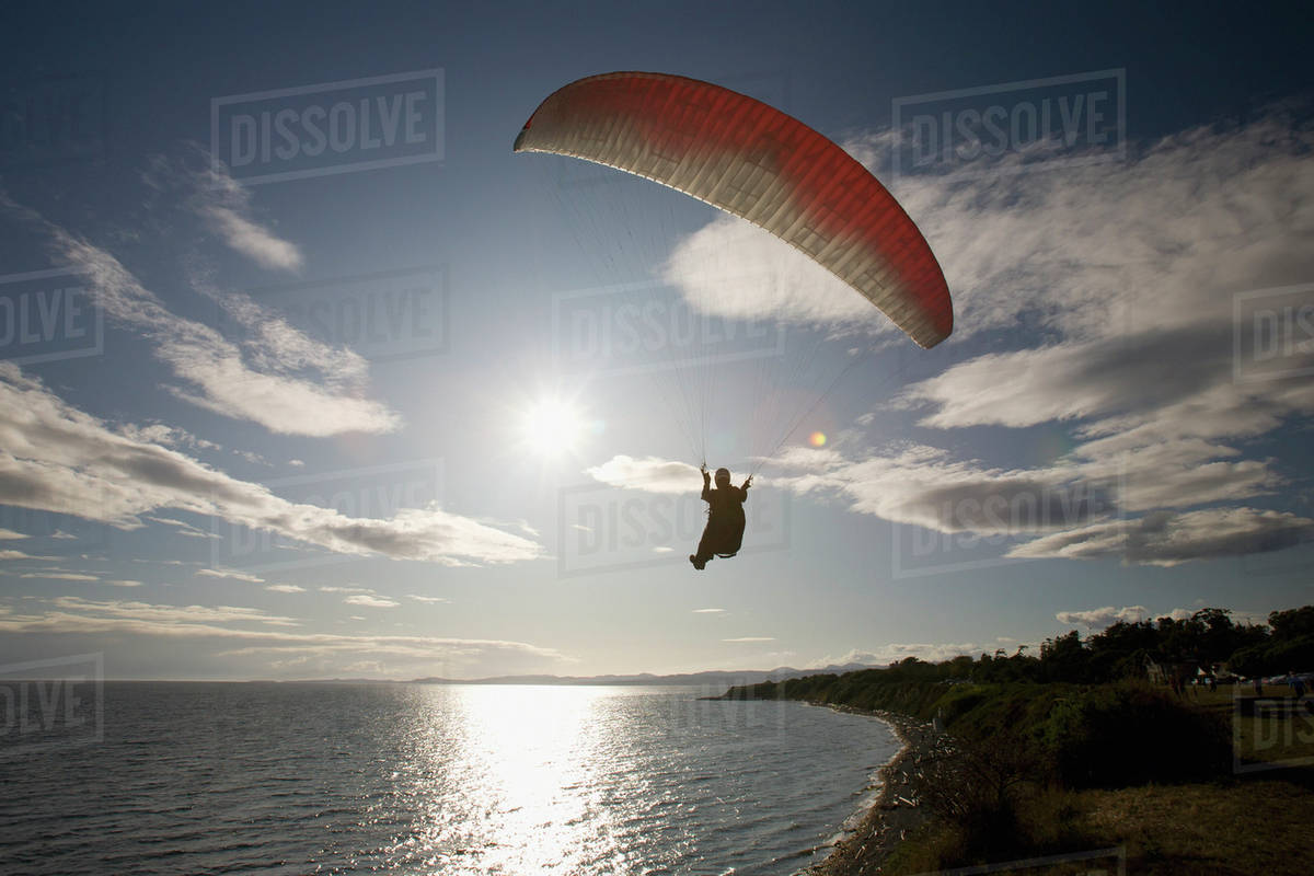 A Man Paragliding Along The Cliffs At Dallas Road; Victoria, Vancouver ...