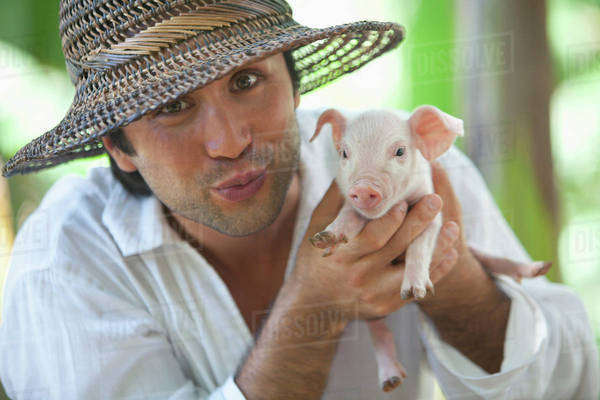 A Man Holds A Baby Pig; Island Of Bohol, Philippines - Royalty-free ...