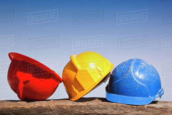 Three Hard Hats In A Row In Primary Colors Red, Yellow And Blue ...