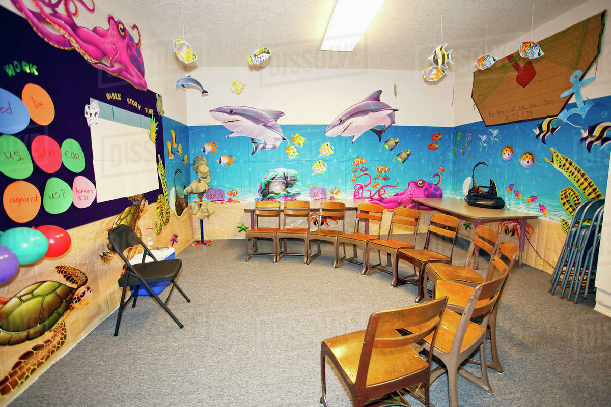 A classroom with a marine life theme and chairs set up in a semi-circle ...