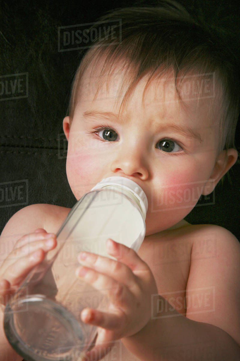A Baby Laying On It's Back Drinking Milk From A Bottle; Edmonton ...