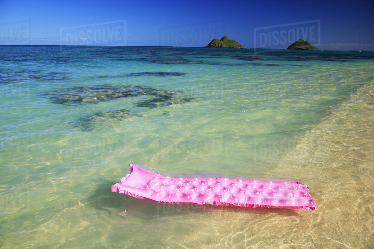 Hawaii, Oahu, Lanikai, Pink Inflated Raft On Clear Ocean Water, Mokulua ...