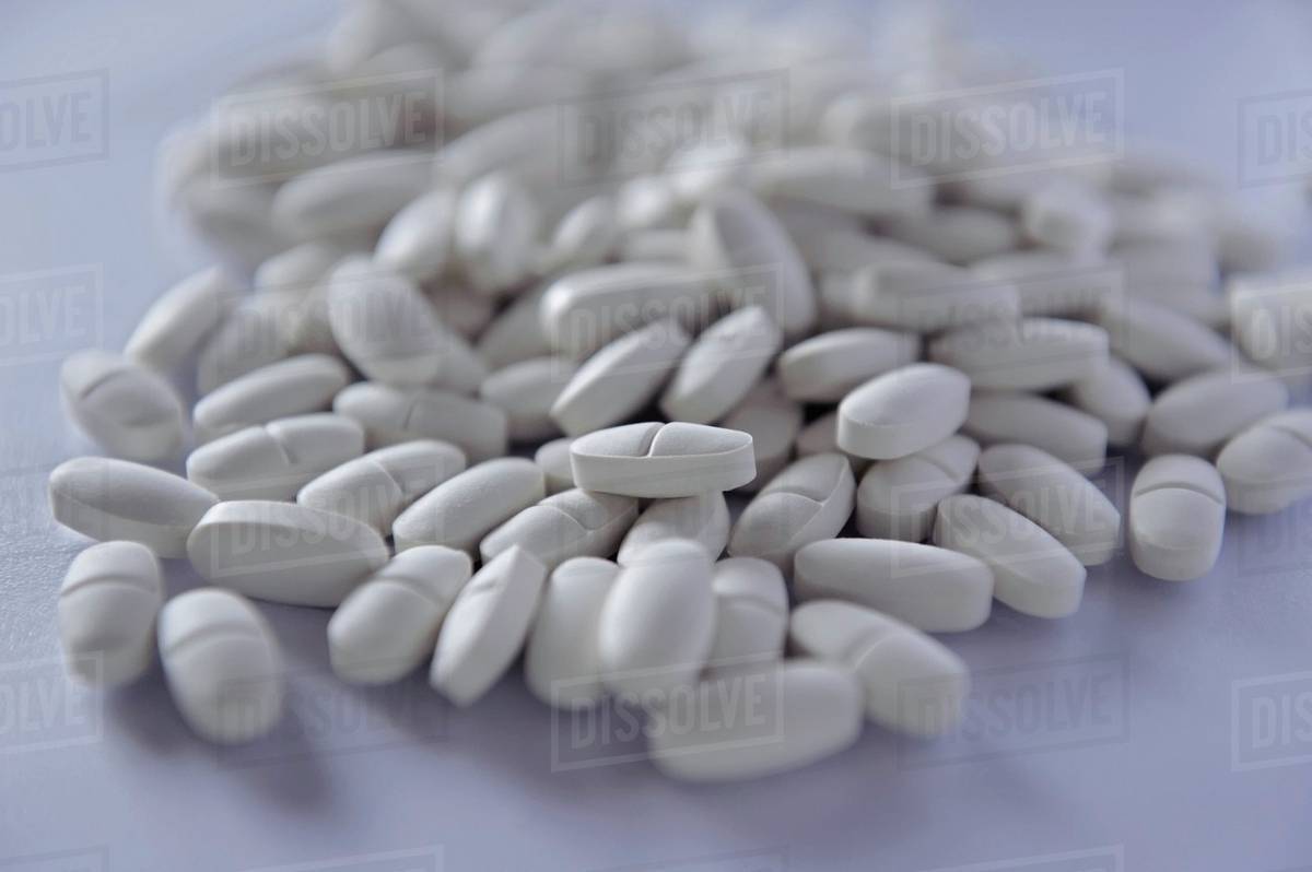 A Pile Of White Pills - Stock Photo - Dissolve