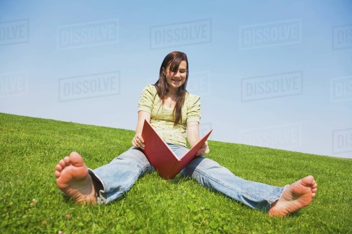 A Girl Reading While Sitting On The Grass - Royalty-free Stock Photo ...