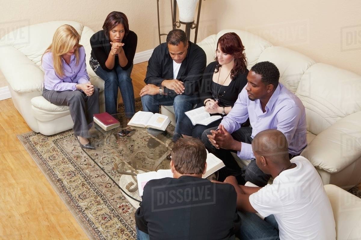 A Group Of Adults Praying With Their Bibles Open - Royalty-free Stock ...