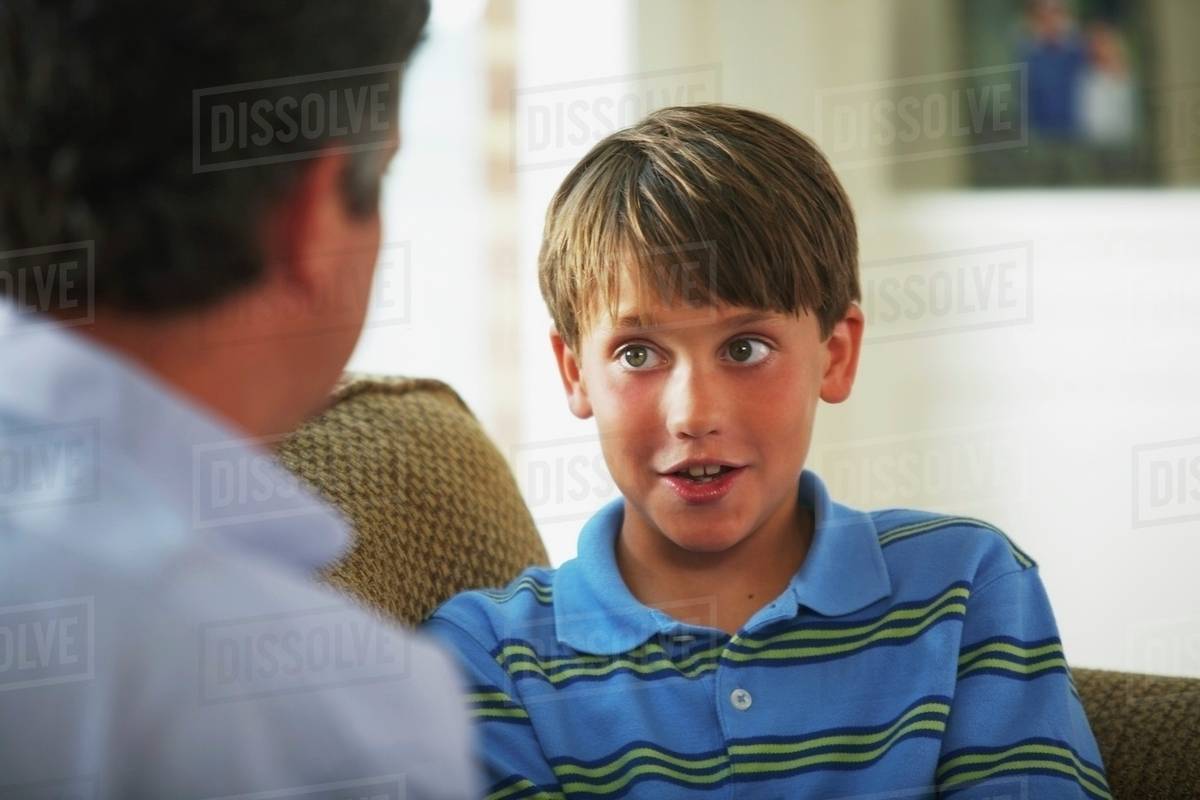 A Father And Son Talking Together - Stock Photo - Dissolve