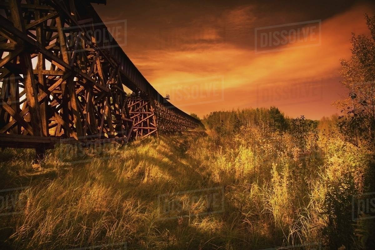 Alberta, Canada; A Train Trestle In A Sunset - Royalty-free Stock Photo ...