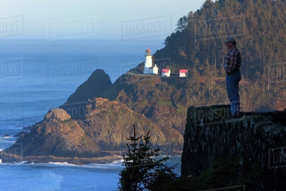 Oregon, United States Of America; A Man Standing On The Edge Of A Cliff ...