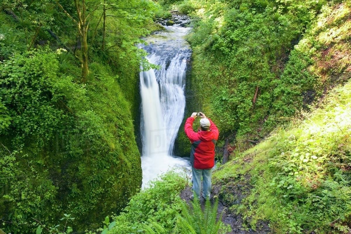 Oregon, United States Of America; A Man Taking A Picture Of Middle ...