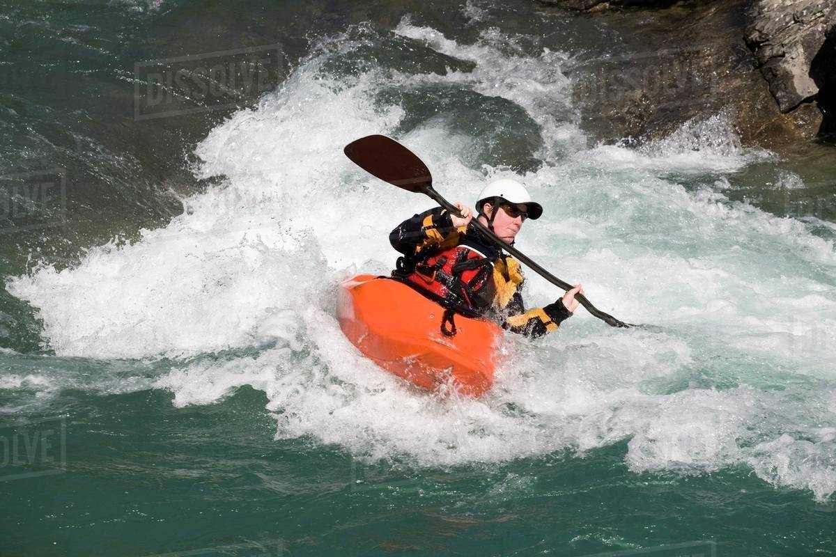 Female White Water Kayaker In Rapids; Alberta, Canada - Royalty-free ...