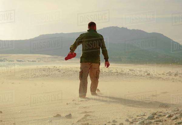 Man Walking On Sand - Stock Photo - Dissolve