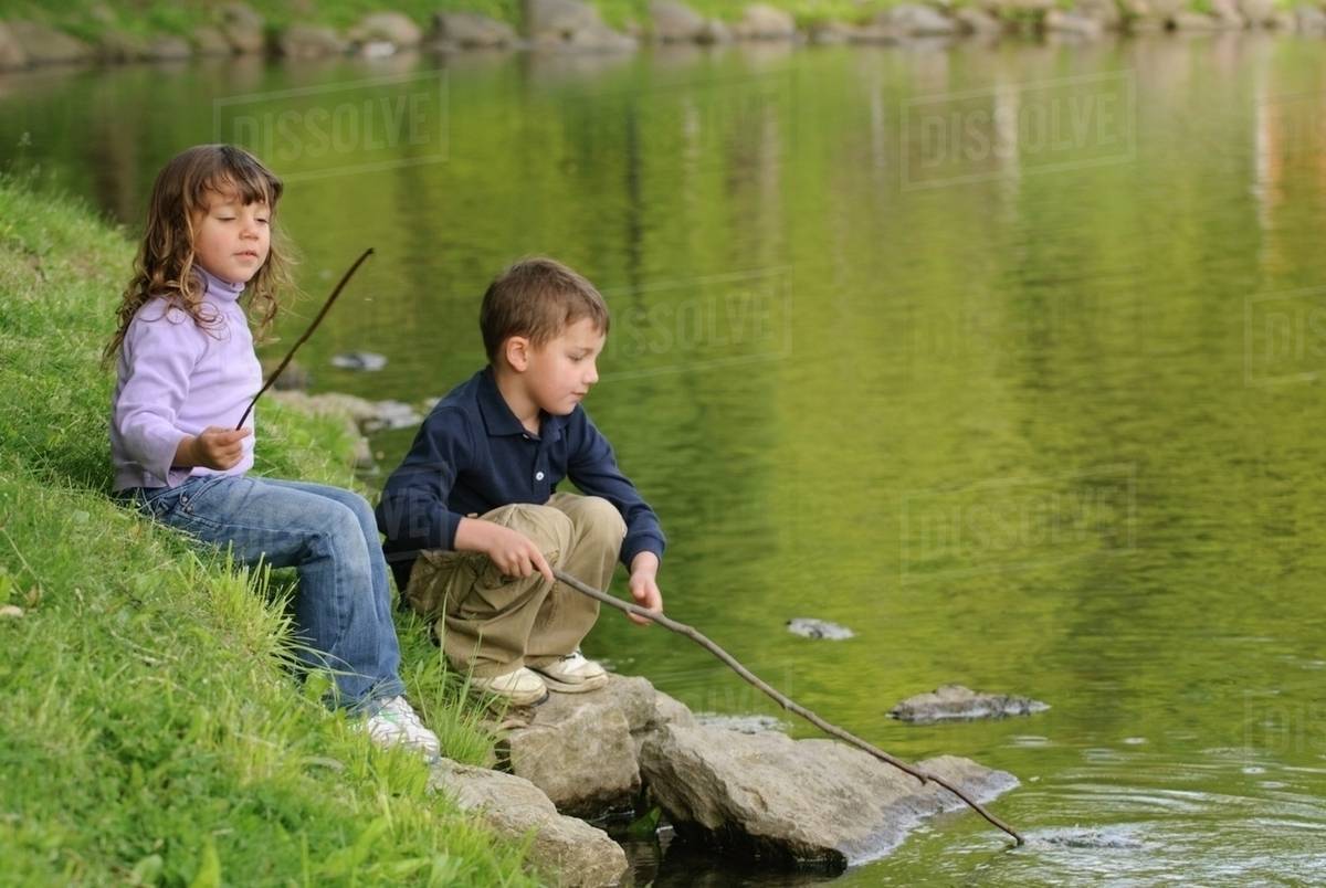 Two Kids Playing In A Pond - Royalty-free Stock Photo | Dissolve