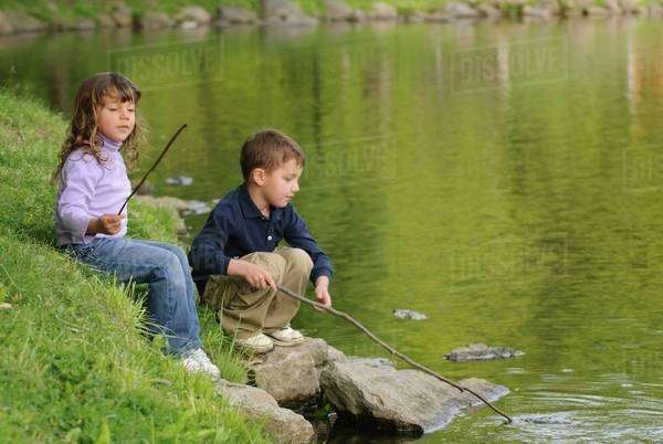Two Kids Playing In A Pond - Royalty-free Stock Photo | Dissolve