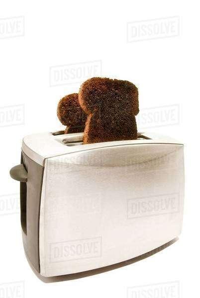 Burnt Toast Popping Out Of A Toaster - Stock Photo - Dissolve