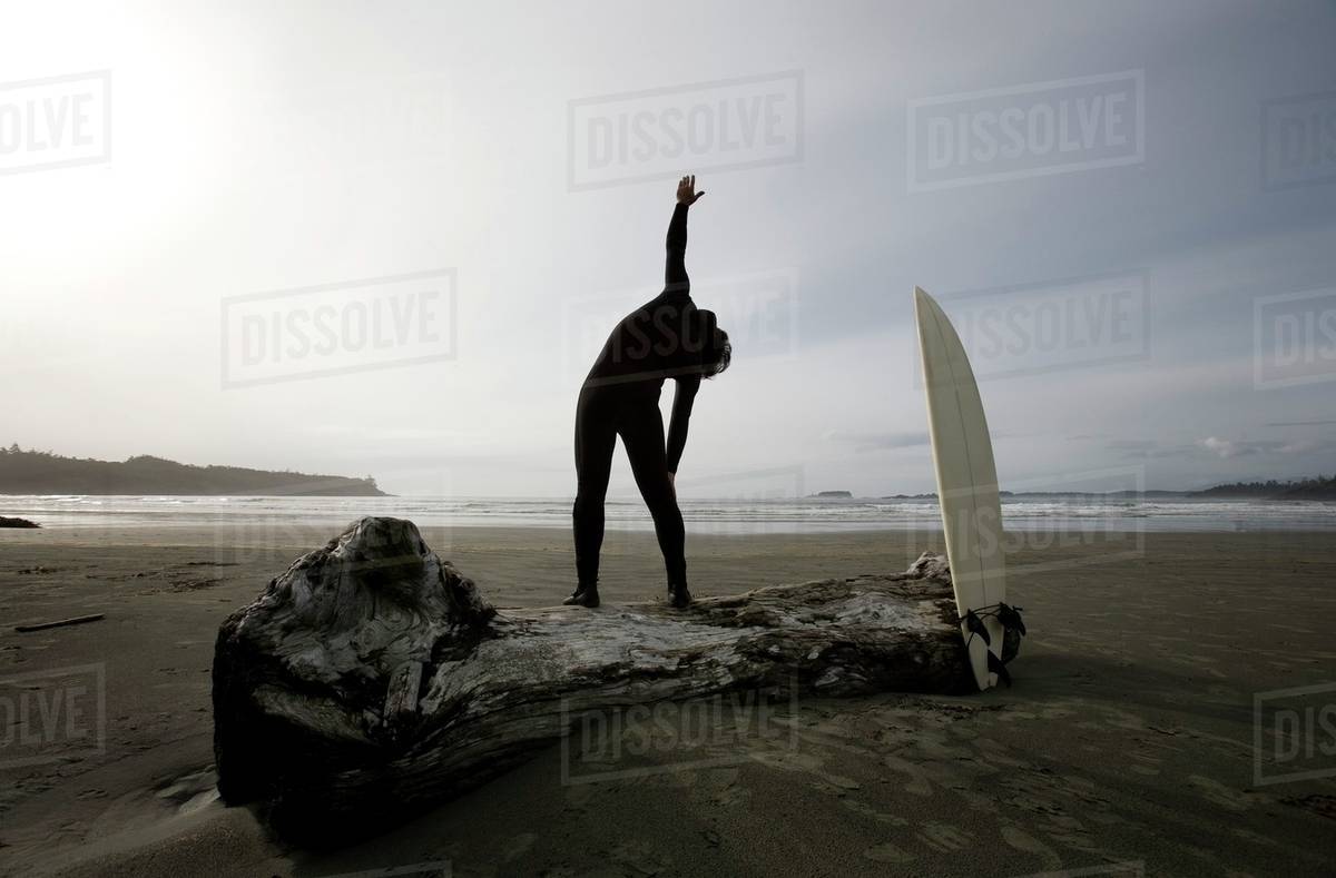 Surfer Stretching On Beach - Royalty-free Stock Photo | Dissolve