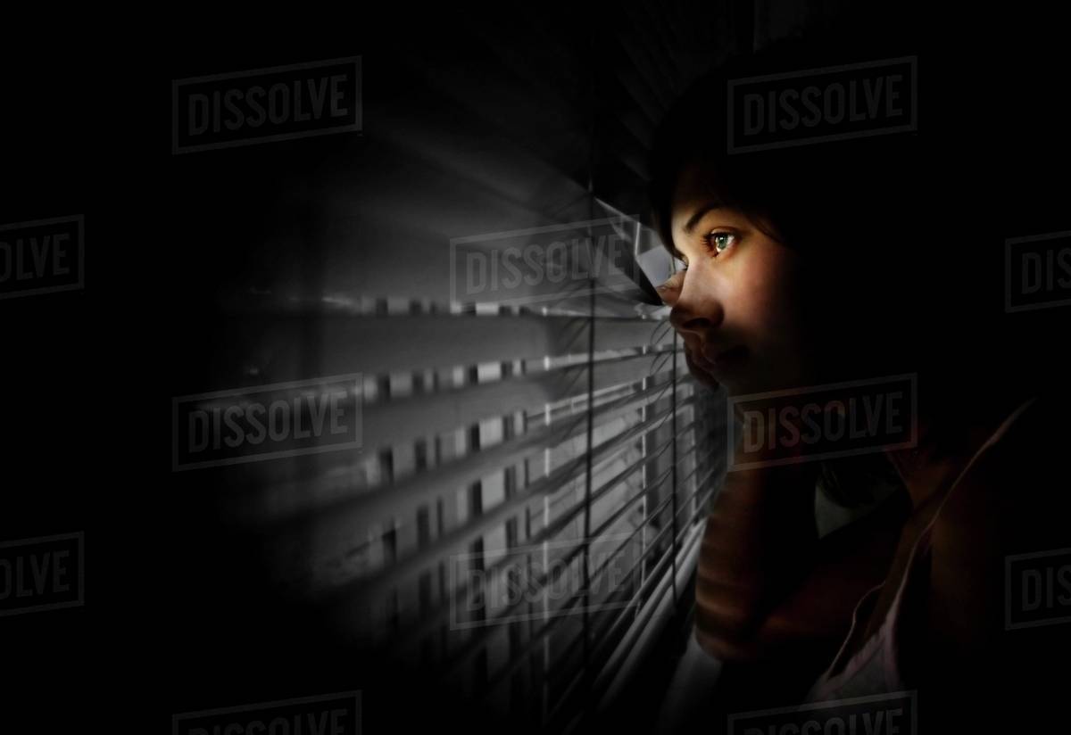 Girl Peeking Out Of Window - Stock Photo - Dissolve