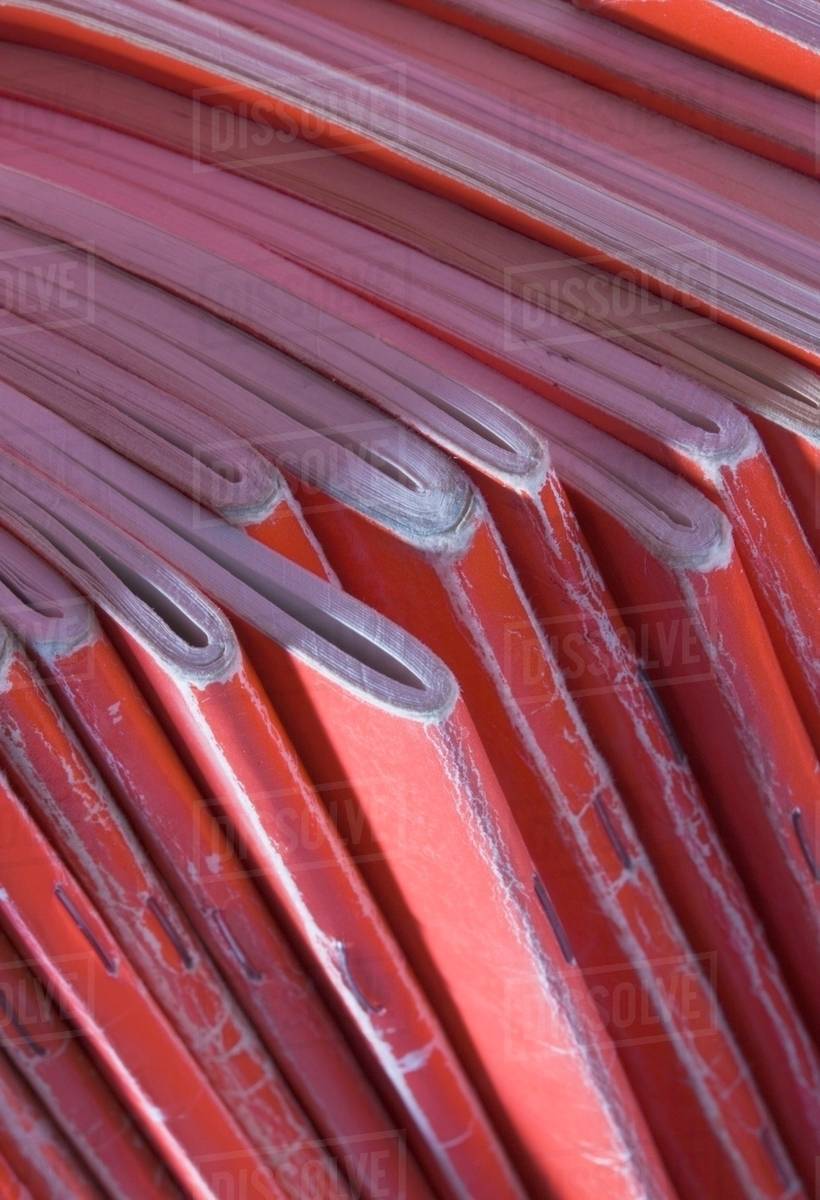 Collection Of Well Used Red Notebooks - Stock Photo - Dissolve