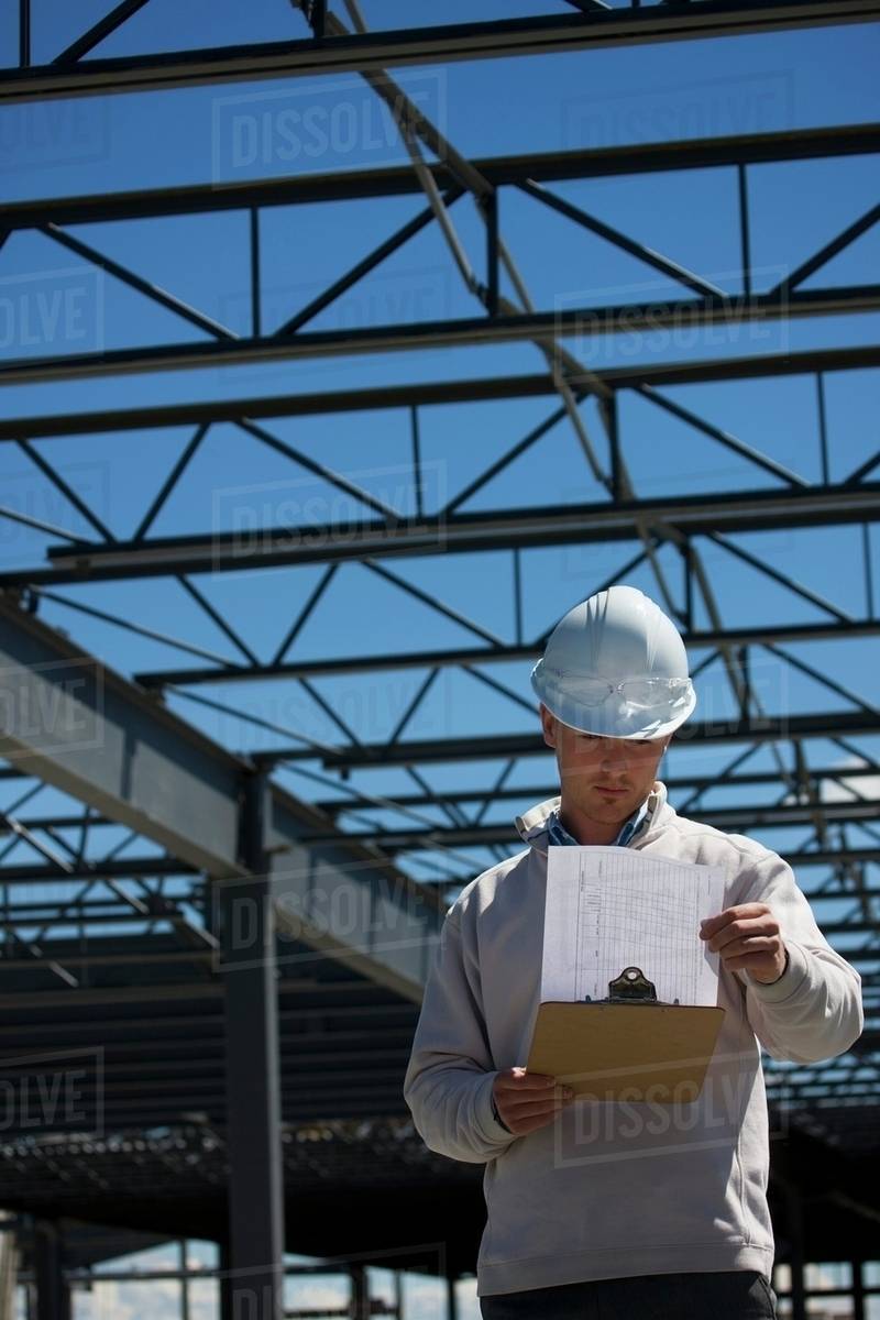 Engineer With Clipboard On Construction Site - Stock Photo - Dissolve