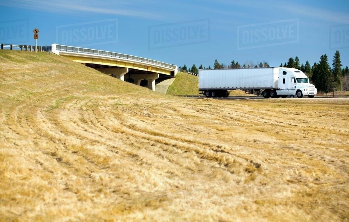Truck Driving Beside Field - Royalty-free Stock Photo | Dissolve