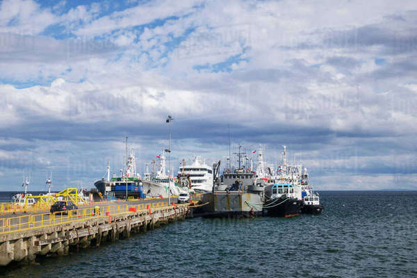 Cruise ship and crab boats at pier in Punta Arenas; Punta Arenas ...