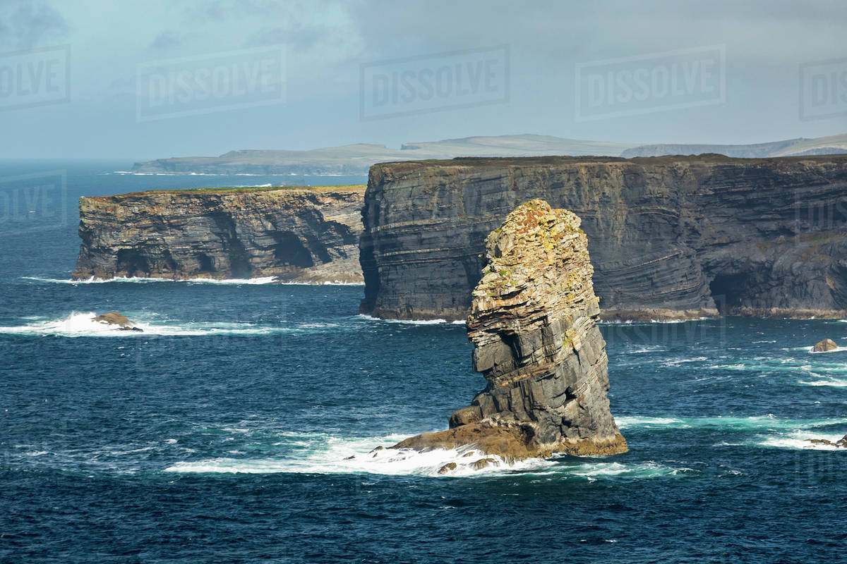 Large sea stack rock structure along rugged dramatic cliff shoreline ...