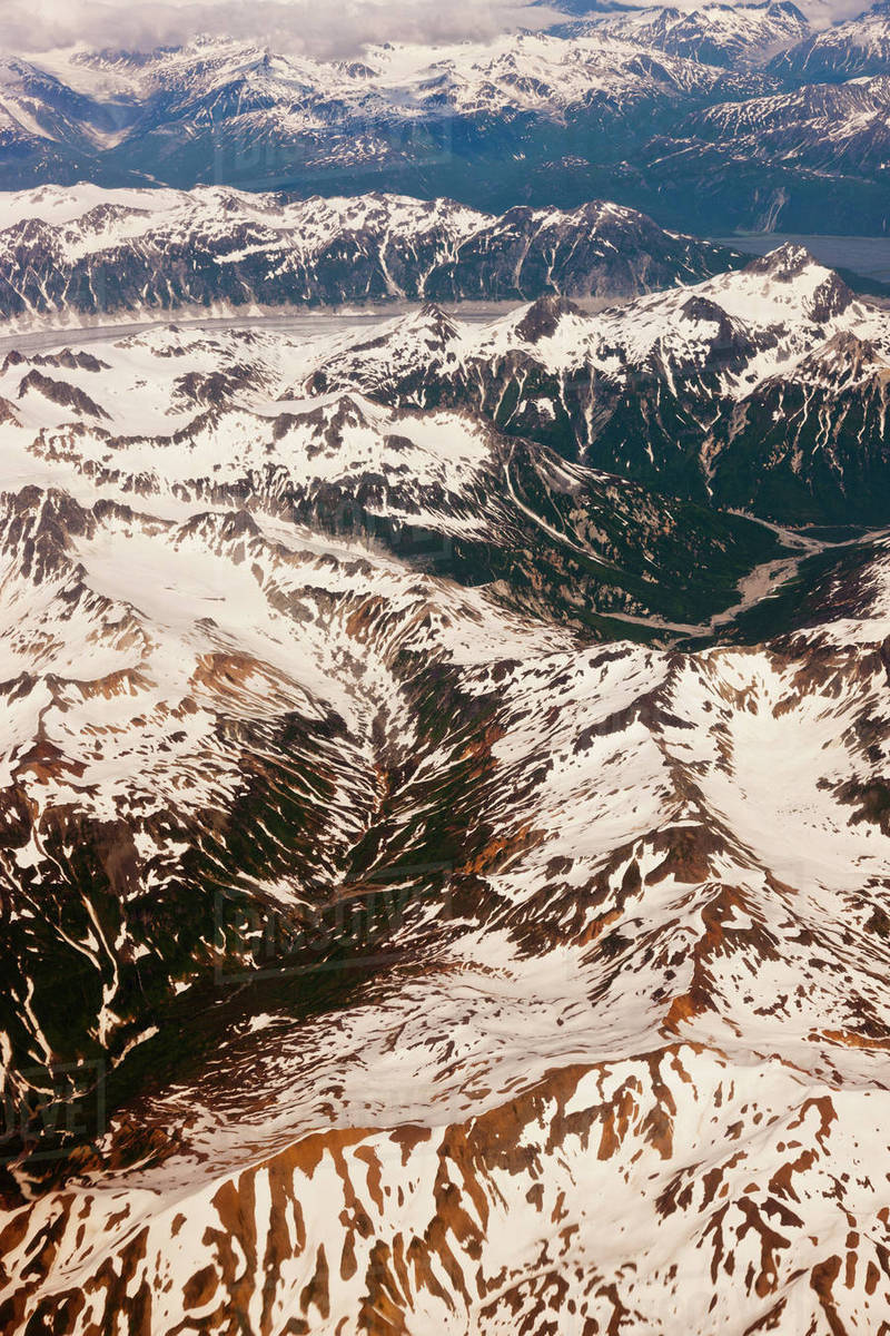 Aerial perspective of glaciers, fjords, and snow-covered moutains in ...