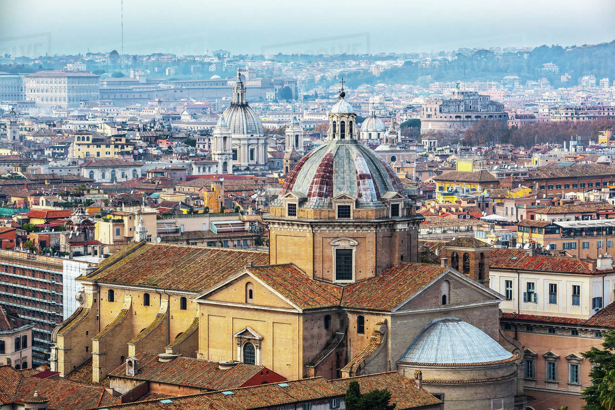 Dome Of Church Roof With Cross And Various Other Buildings; Rome, Italy ...