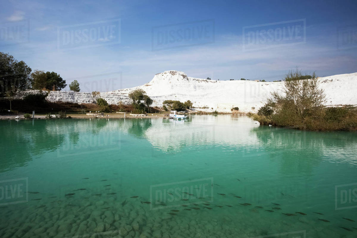 Turquoise Water In A Pool Reflecting A White Wall Of Mineral Deposits ...