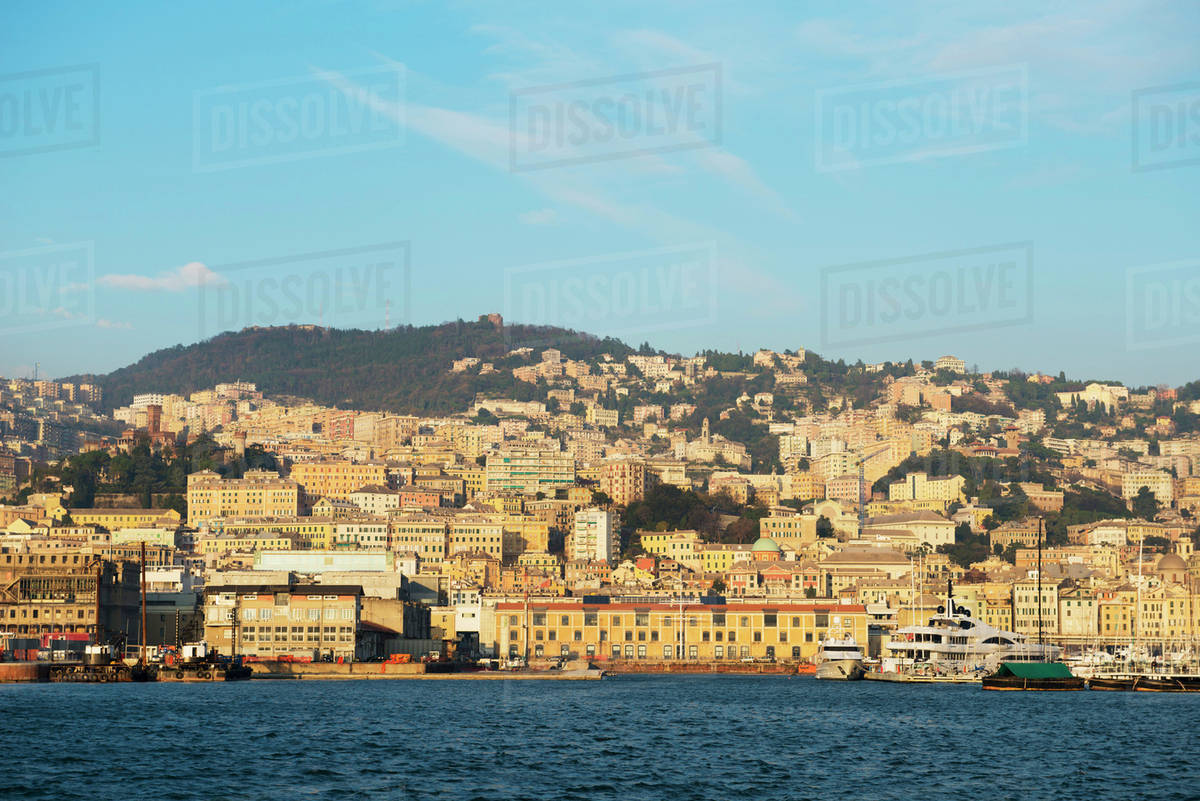 Boats in the harbour and buildings on the waterfront; Genoa, Liguria ...