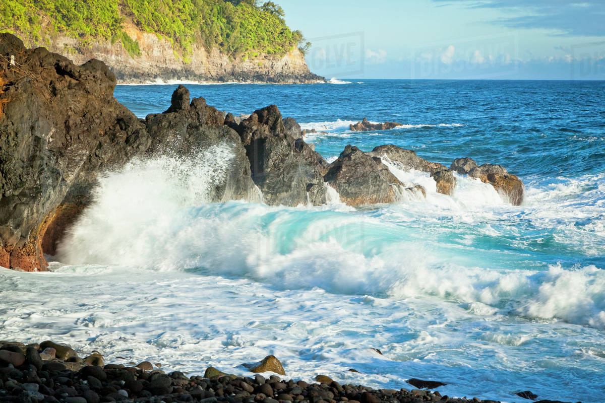 Wave crashing against the rocks along the coastline; Island of Hawaii ...