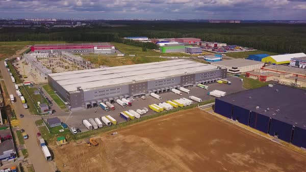 Buildings of cargo center. Big trucks parked near warehouse. Aerial ...