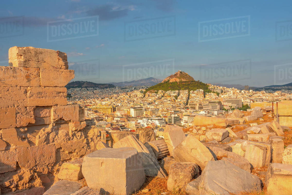 Greece. Sunset in Athens. Marble ruins in the foreground. View from a ...