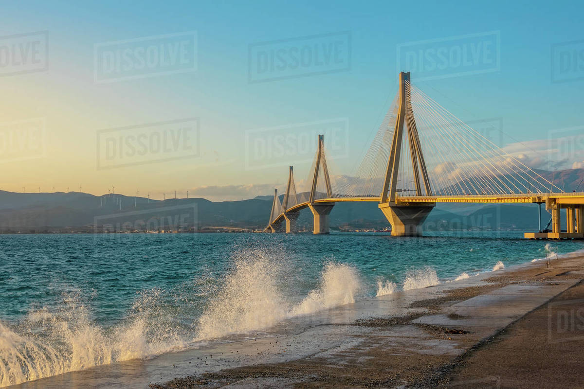Greece. Rion Antirion Bridge over the Gulf of Corinth. Sunset and spray ...