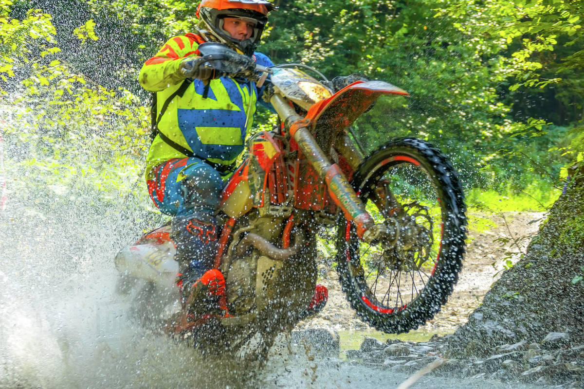 Sunny summer day. A lot of splash of water when an athlete lifted the ...