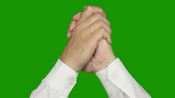 Green background (Chroma Key). Hands of a man in a white shirt are ...