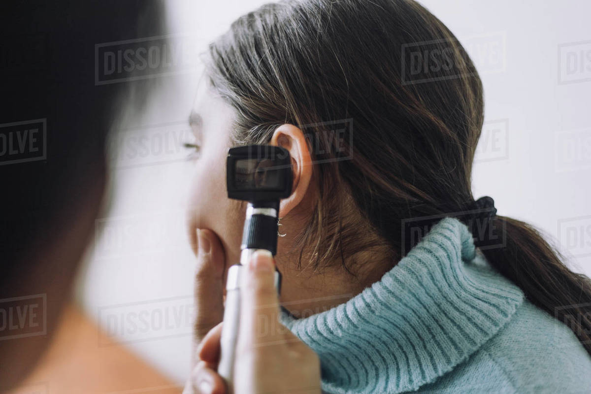 Doctor examining patient's ear using Otoscope at hospital - Royalty ...