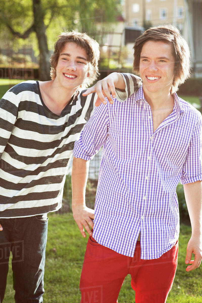 Two cheerful friends laughing together outdoors - Stock Photo - Dissolve