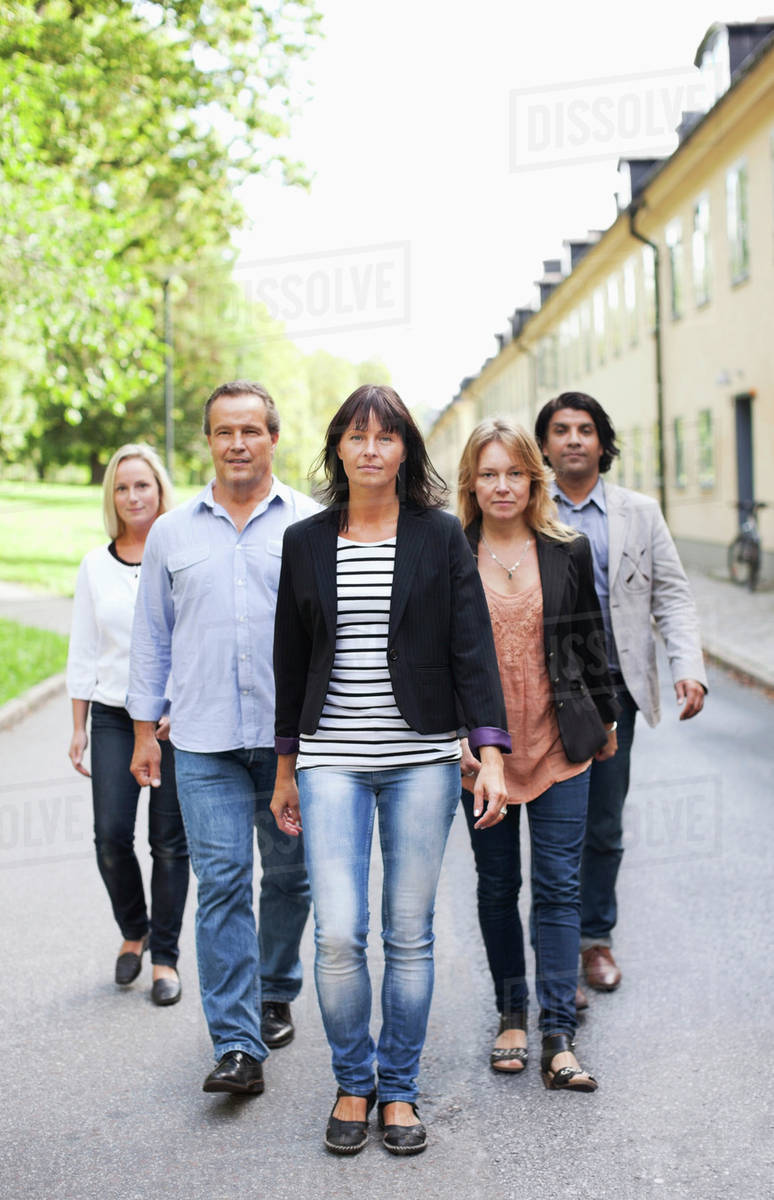 Group of people walking in an arrow shaped formation - Royalty-free ...