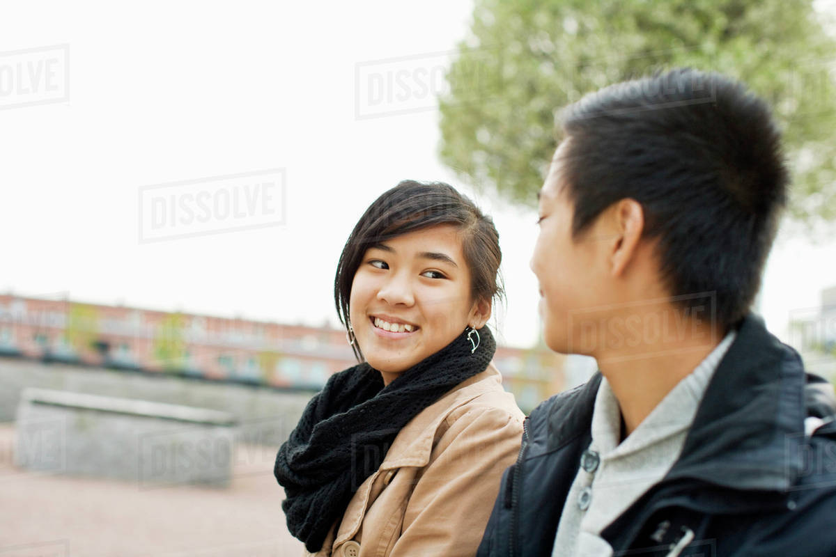 Happy teenage friends looking at each other and smiling - Royalty-free ...