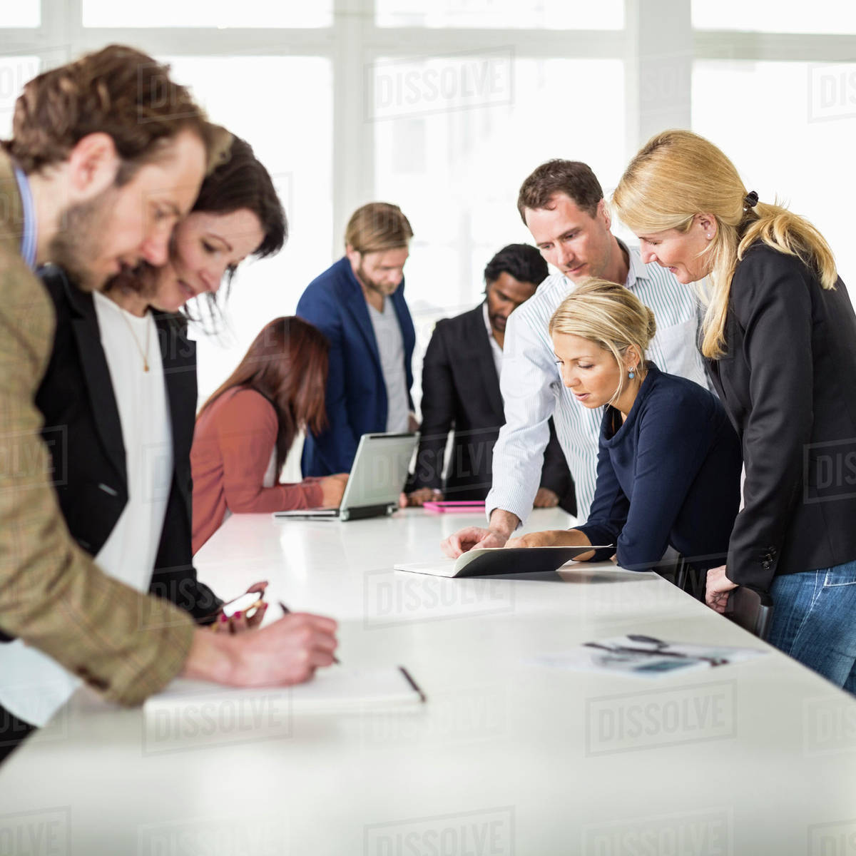 Group Of Business People Working Together At Desk In Office Royalty Group Of Business People Working Together At Desk In Office Royalty