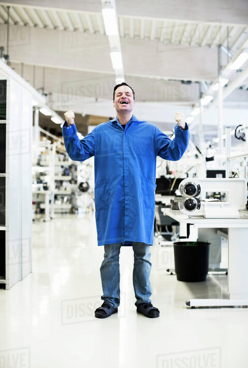 Full length of successful male electrician screaming in industry ...