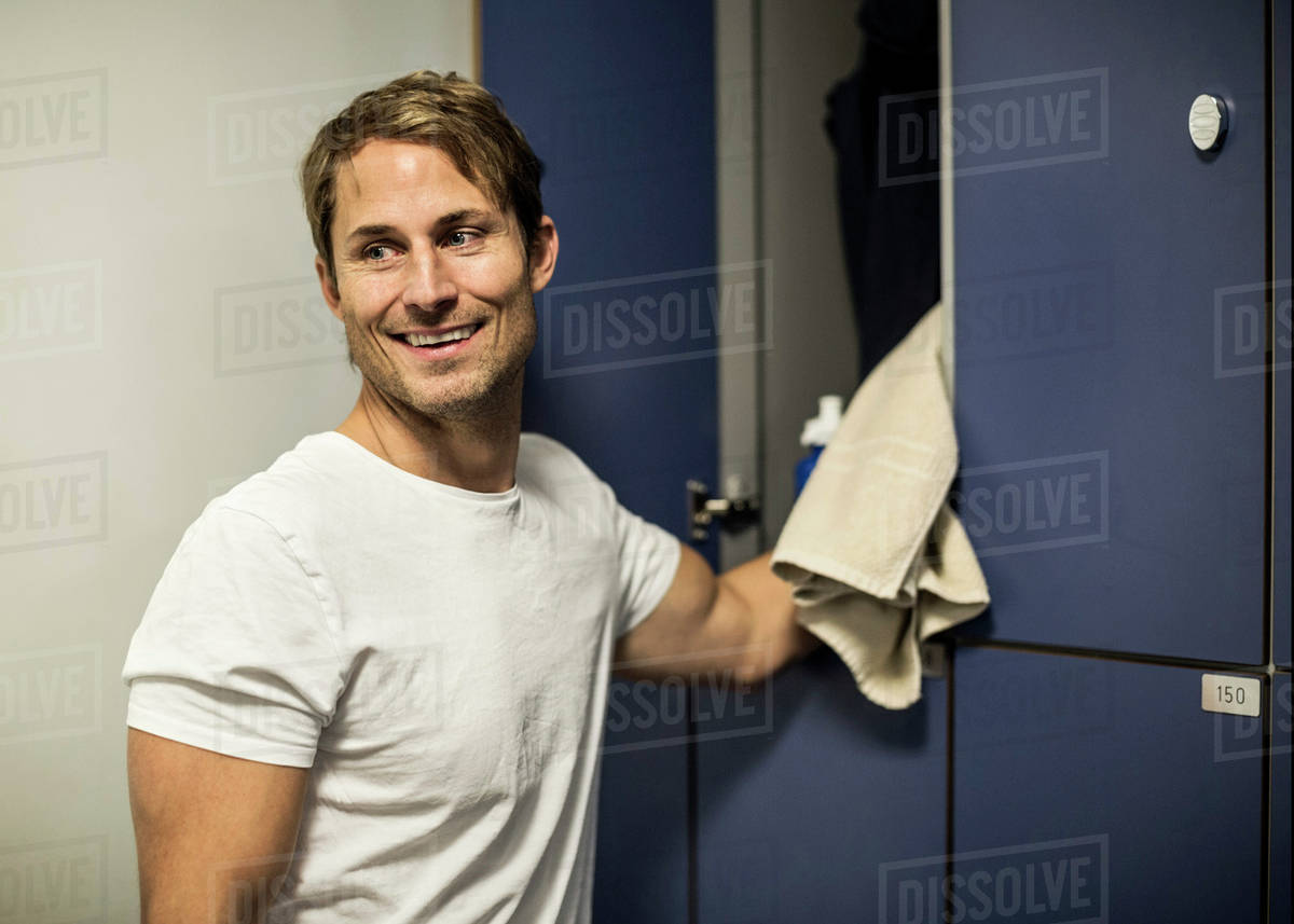 Happy man locker room at health club - Stock Photo - Dissolve
