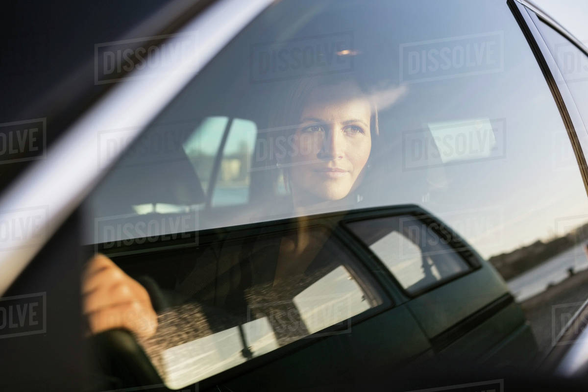 Businesswoman looking through window while driving car - Stock Photo ...