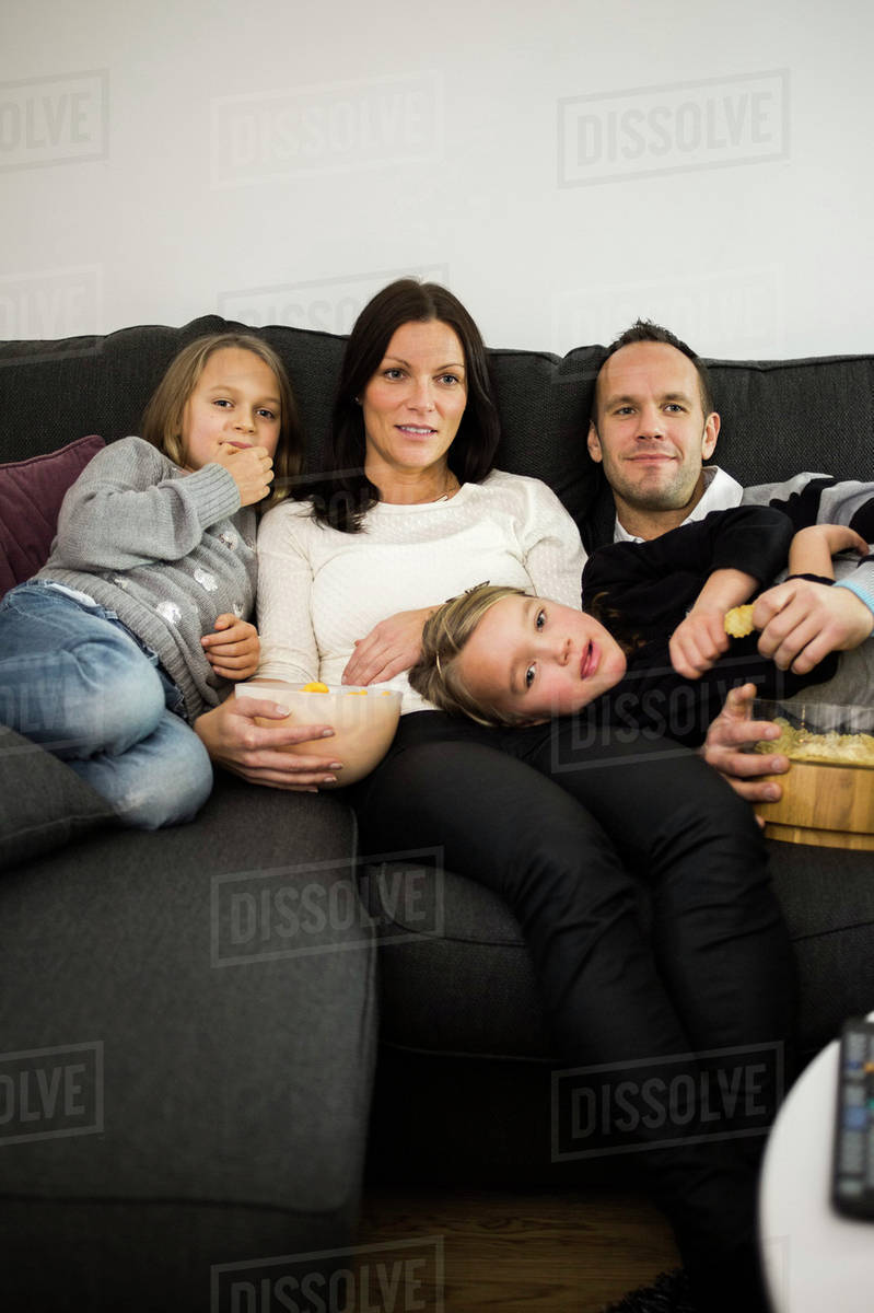 Family watching TV in living room - Royalty-free Stock Photo | Dissolve