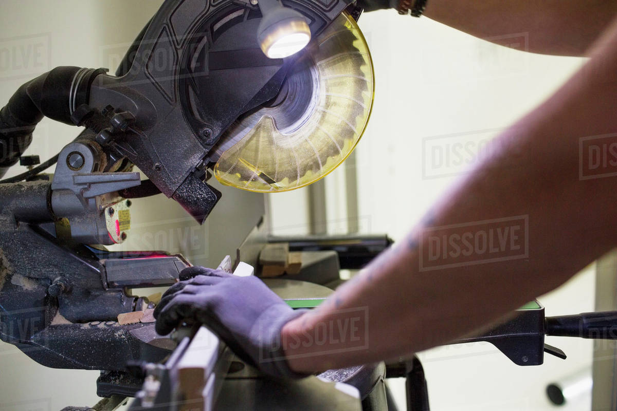 Construction worker using electric saw at site - Royalty-free Stock ...