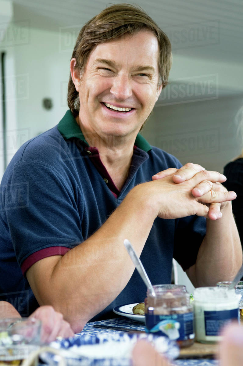 Happy man with closed hands - Royalty-free Stock Photo | Dissolve