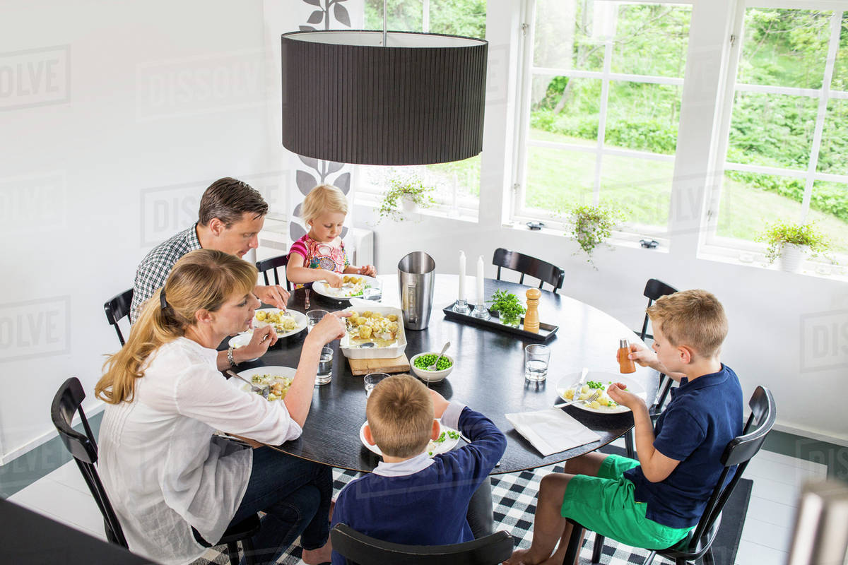 Family having lunch at home - Royalty-free Stock Photo | Dissolve